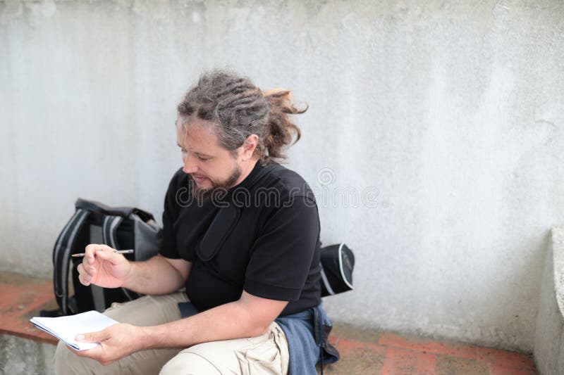 Journalist Writing Notes Outdoors, Taking a Break from Reporting Stock ...
