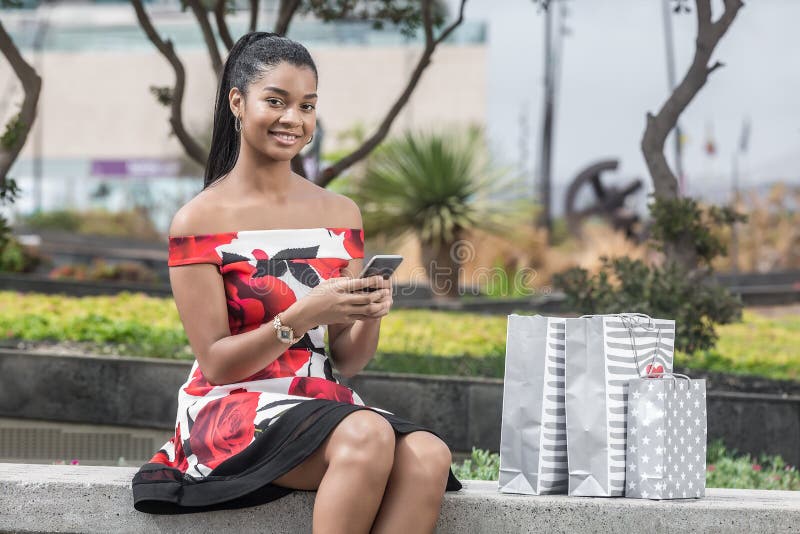 Joyful Adult African American Woman Interacting With Smartphone While
