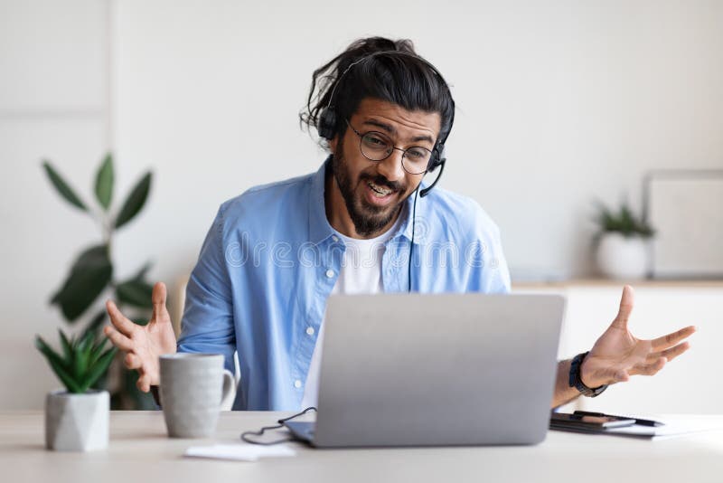 Joyful Arab Man in Headset Having Video Call on Laptop in Office, Stock ... Joyful Arab Man in Headset Having Video Call on Laptop in Office, Stock ...