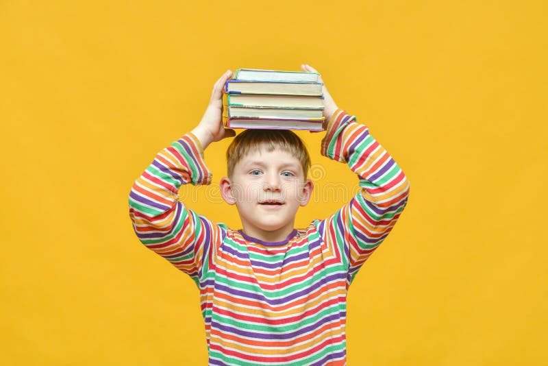 A Joyful Boy Holds a Bundle of Textbooks on His Head and Wishes To Gain ...