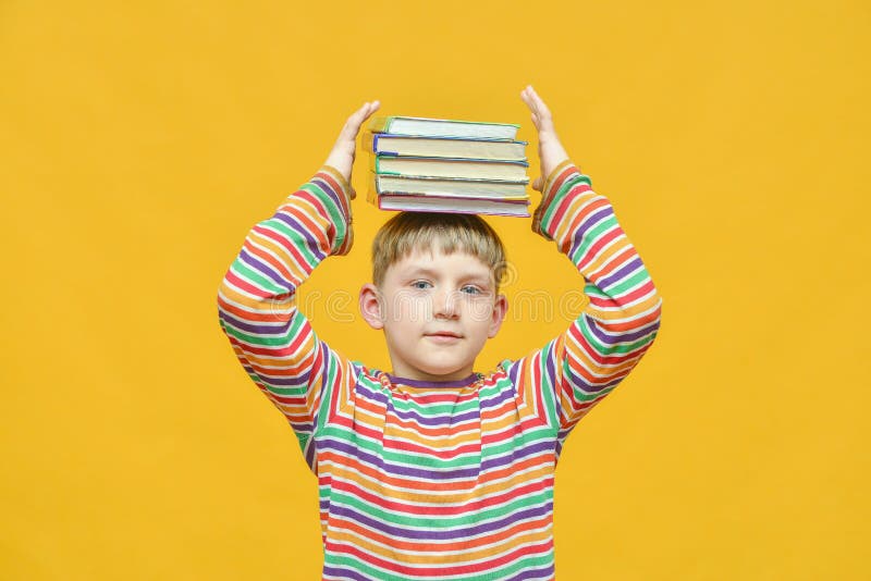 A Joyful Boy Holds a Bundle of Textbooks on His Head and Wishes To Gain ...