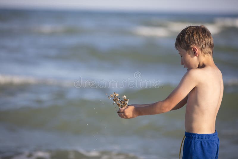 Joyful Boy Near the Sea Throws Seashells. Stock Photo - Image of play ...