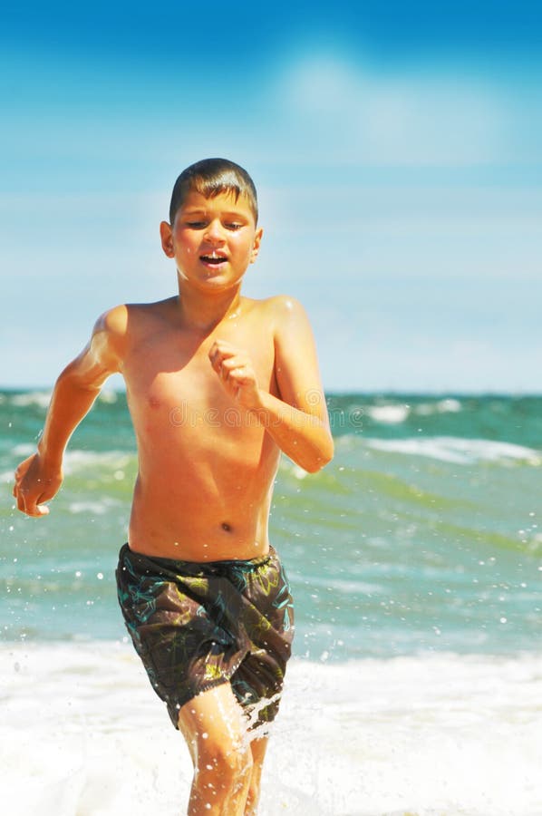 Joyful Boy on an Ocean Coast Stock Photo - Image of blue, sand: 10553698