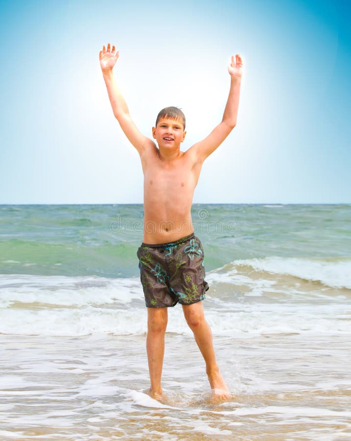 Joyful Boy on an Ocean Coast Stock Photo - Image of blue, sand: 10553698