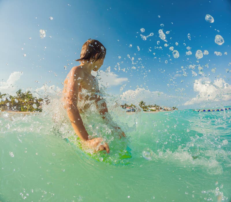Joyful Boy Plays in the Sea, Creating Playful Splashes and Enjoying the Waves Stock Image ...