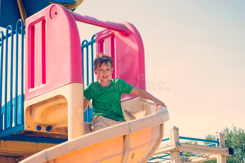 A Joyful Boy Skate on a Children`s Roller Coaster in the Park. Stock ...