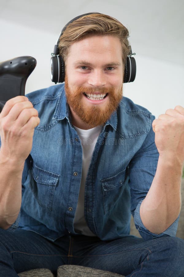 Joyful Bristled Young Man Holding Video Game Controller Stock Image ...