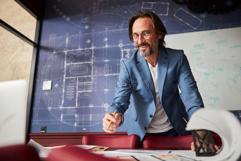 Friendly Professor Working with Pleasure in Sunlit Classroom Stock ...