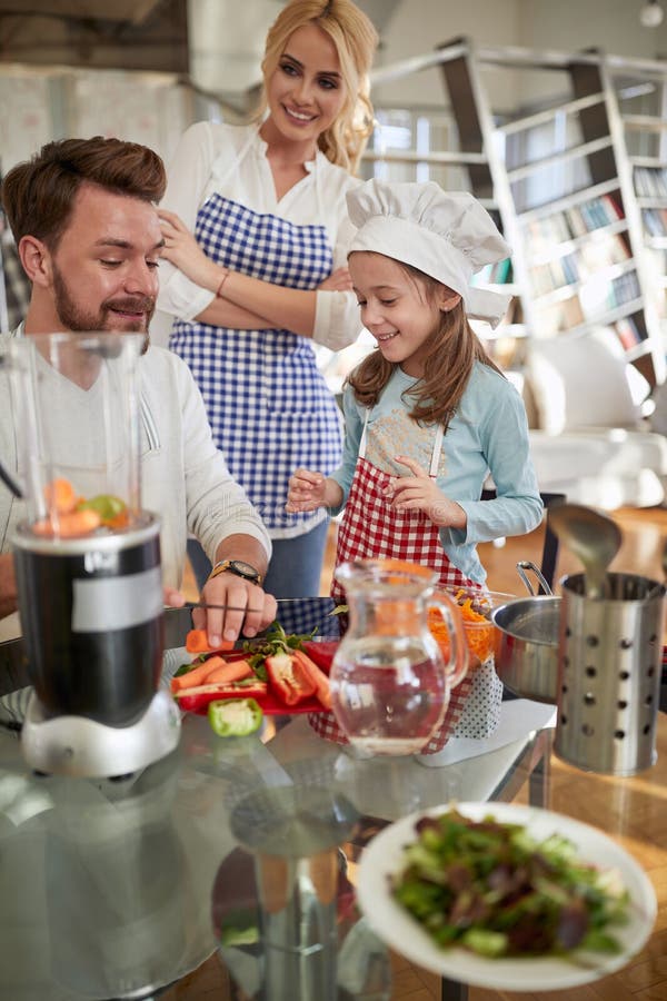 Joyful Caucasian Parents Cooking with Daughter Stock Photo - Image of ...