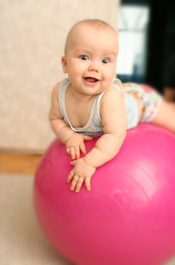 The joyful child on a ball stock image. Image of baby - 5151725