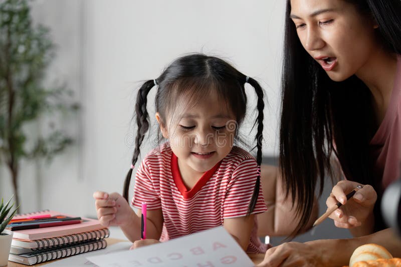 Joyful Child Engaged in Learning with Parent, Exploring Letters and ...