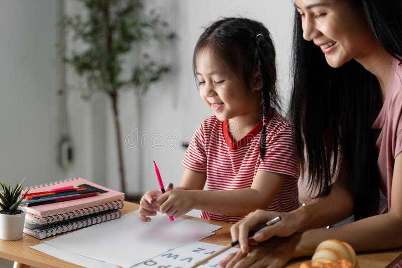 Joyful Child Engaged in Learning with Parent, Exploring Letters and ...