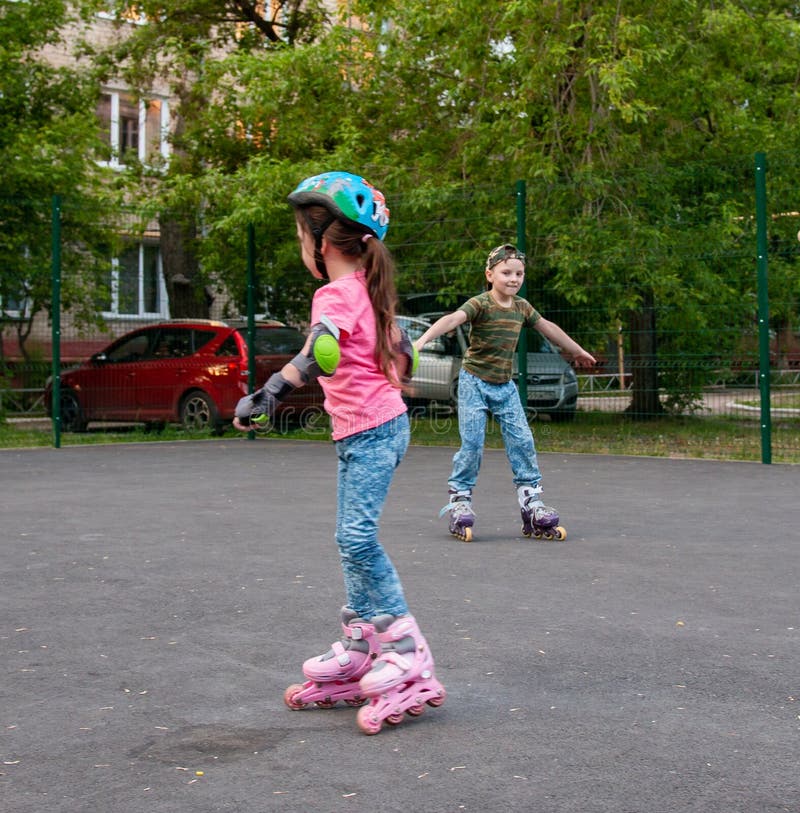 Joyful Children Rollerblading in the Playground Stock Photo - Image of ...