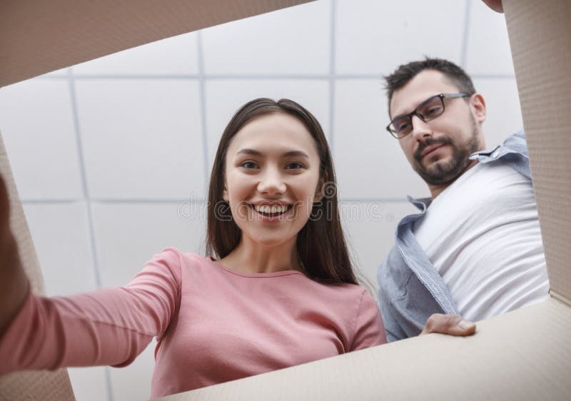 Joyful Couple Opening the Box and Looking on Surprise Stock Photo ...