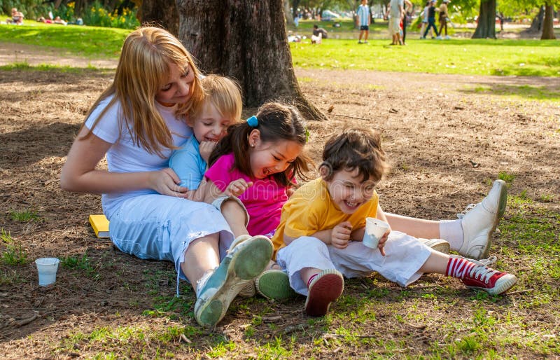 Joyful Family in the Park on the Grass Stock Image - Image of people ...