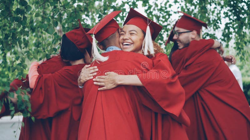 Joyful Friends Graduating Students in Gowns and Mortarboards are ... Joyful Friends Graduating Students in Gowns and Mortarboards are ...