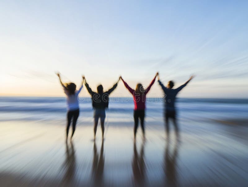 Joyful Friends Running on Beach at Sunset, Motion High Quality Image ...