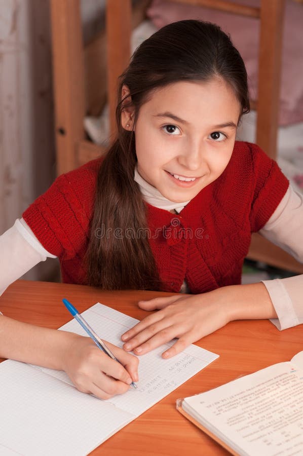 Girl Doing Homework in a Notebook Stock Image - Image of notebook ...