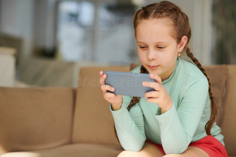 Joyful Girl Playing Game on Smartphone Stock Photo - Image of child ...