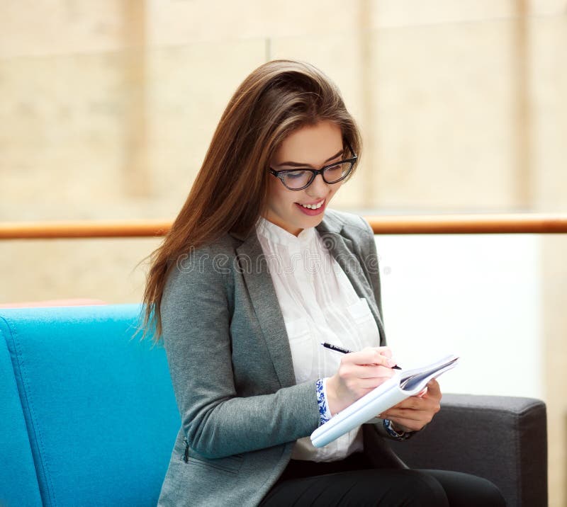Joyful Girl Student Writing in Notebook Indoors Stock Photo - Image of ...