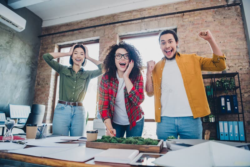 Joyful Group of Young Professionals Celebrating Success in a Creative ...