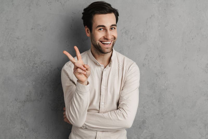 Joyful Handsome Guy Smiling and Showing Peace Sign Stock Image - Image ...