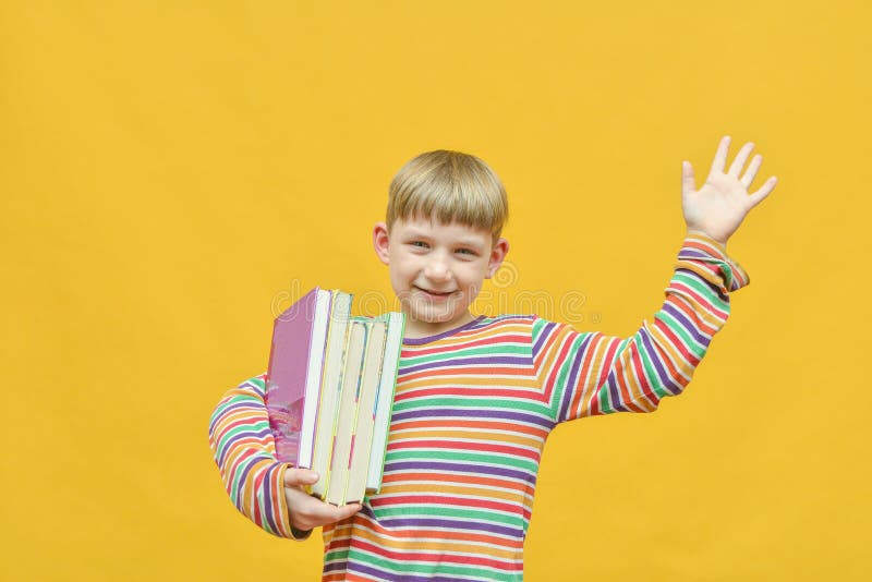 Joyful and Happy Boy Holding a Pack of Textbooks and Waving His Hand ...