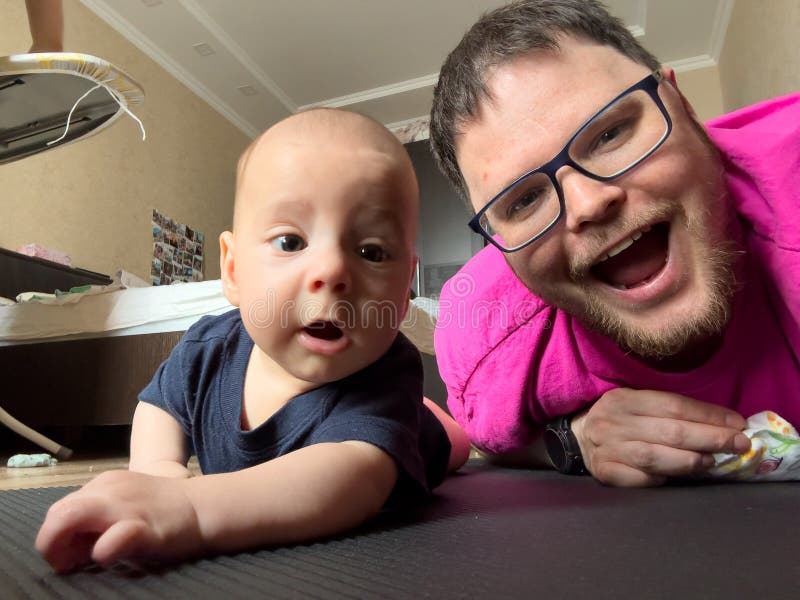 Joyful Man and Curious Baby Indoors Stock Photo - Image of indoor ...
