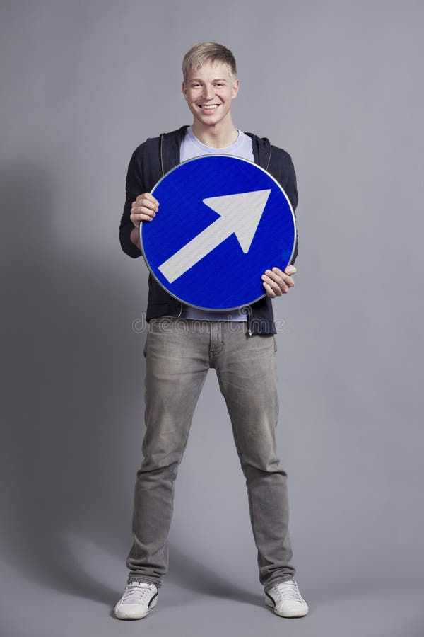Joyful Man Holding Round Blue Sign with Arrow. Stock Image - Image of ...