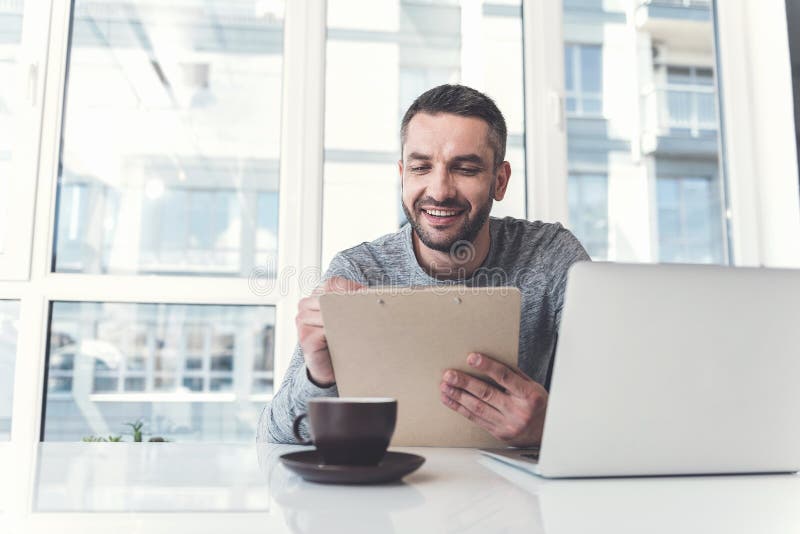Joyful Man is Looking at His Notepad Stock Image - Image of beverage ...