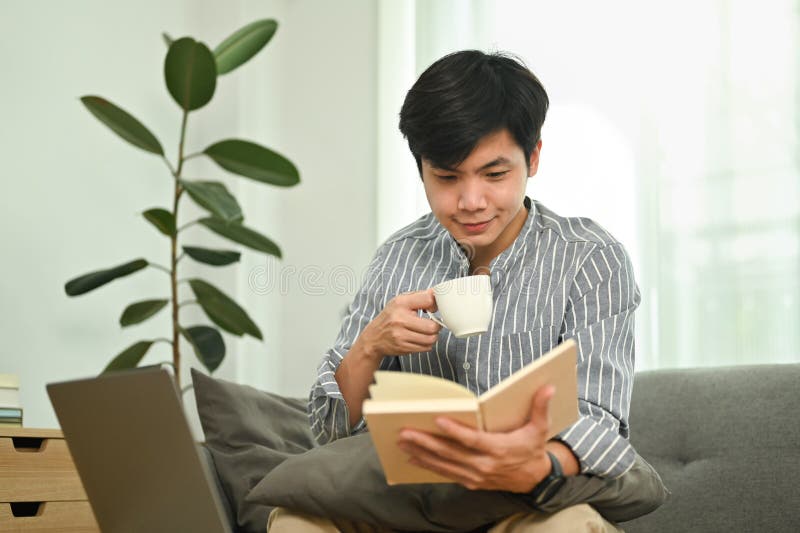 Joyful Millennial Man Drinking Coffee and Checking His Working Schedule ...