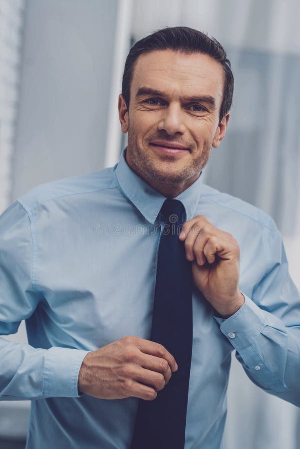 Joyful Positive Man Holding His Tie Stock Photo - Image of adult ... Joyful Positive Man Holding His Tie Stock Photo - Image of adult ...