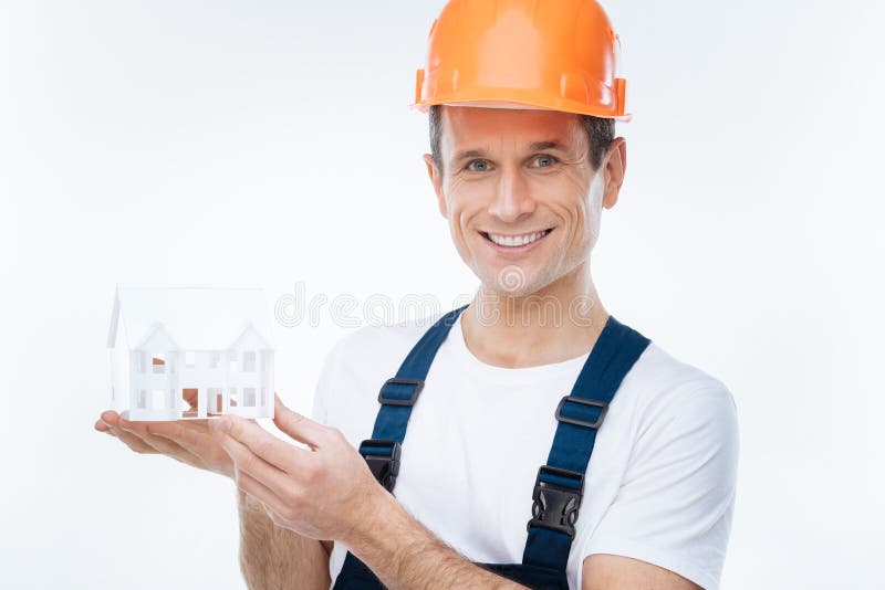 Joyful Positive Man Holding a House Model Stock Photo - Image of model ... Joyful Positive Man Holding a House Model Stock Photo - Image of model ...
