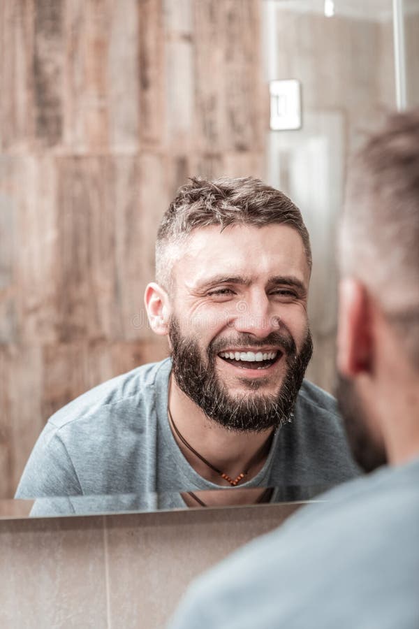 Joyful Positive Man Smiling To His Reflection Stock Photo - Image of ... Joyful Positive Man Smiling To His Reflection Stock Photo - Image of ...