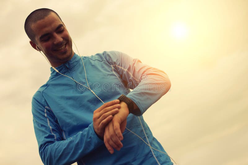 Joyful Runner Looking at Smart Watch. Focus on Face Stock Image - Image ...