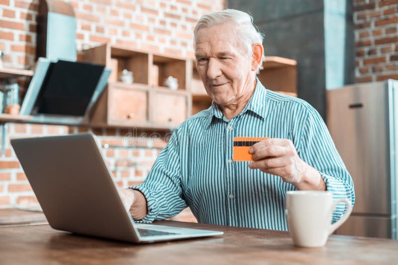 Joyful Senior Man Using a Credit Card Stock Photo - Image of connected ...