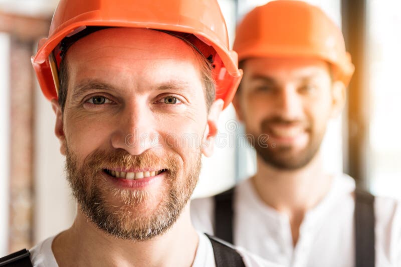 Joyful Smiling Constructors in Orange Helmets Stock Photo - Image of ...