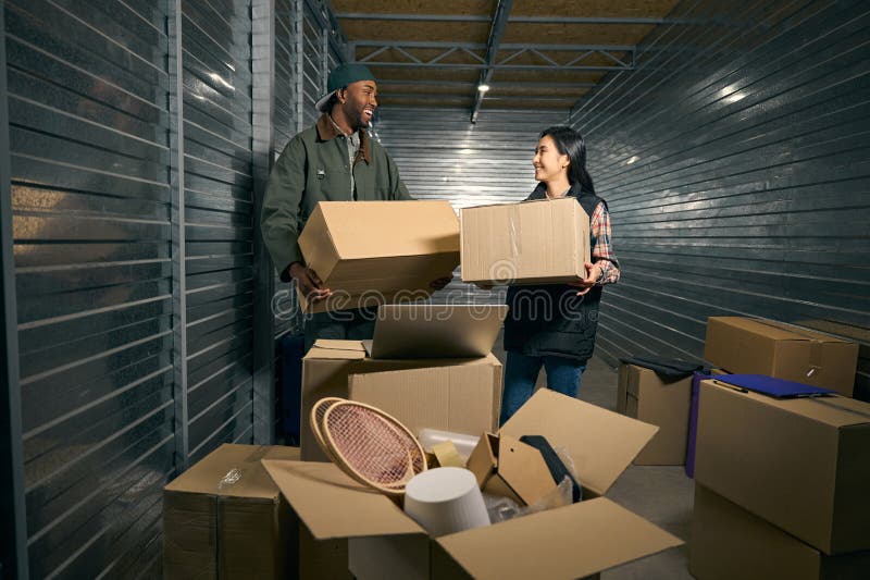 Team of Cheerful Warehouse Workers Unloading Goods Together Stock Photo ...