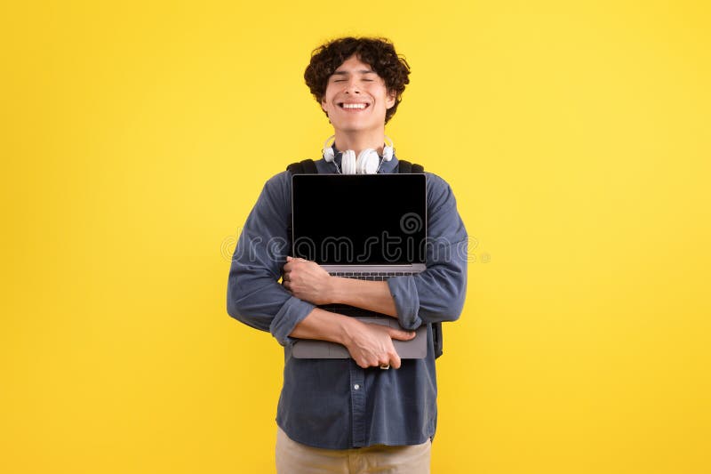 Joyful Student Guy Hugging Laptop Computer Posing Over Yellow ...