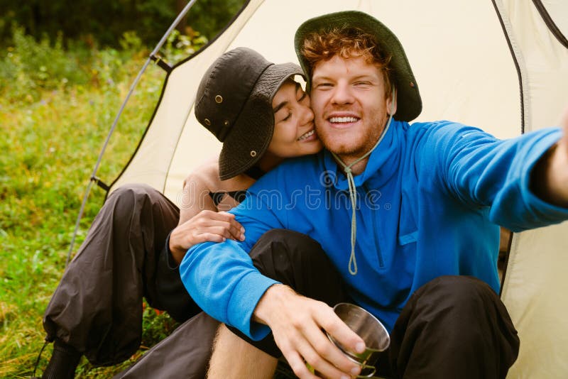 Joyful Tourist Couple Taking Selfie While Sitting At Camping Tent In