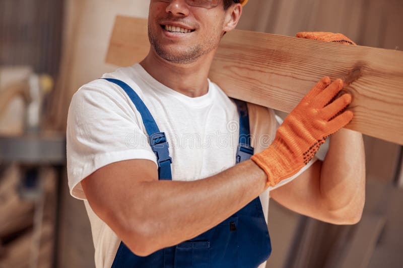 Joyful Worker Carrying Timber Wood Plank at Construction Site Stock ...