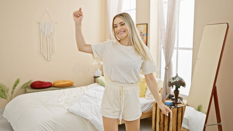 Joyful Young Blonde Woman Confidently Smiling Dancing Around Her Bedroom A Beautiful Morning