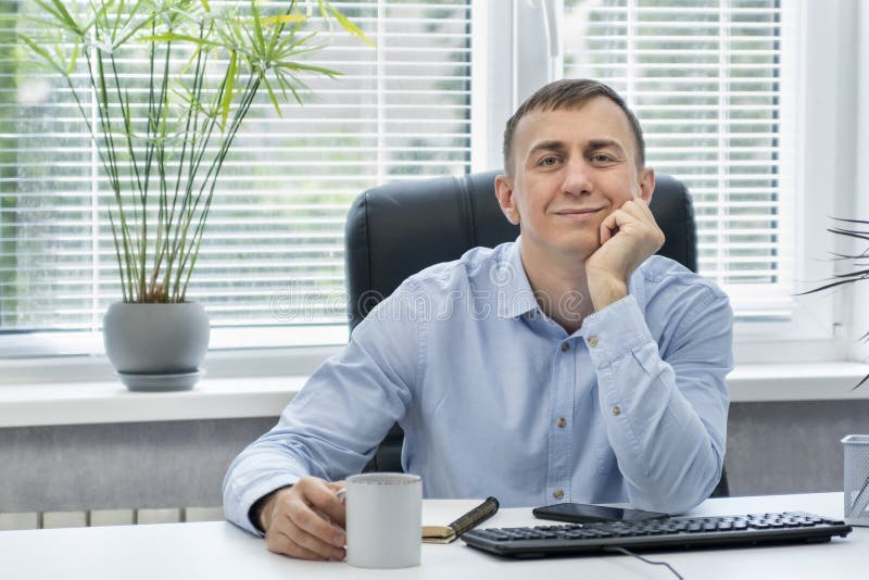 Joyful Young Businessman at Table of His Office. Director at the ...