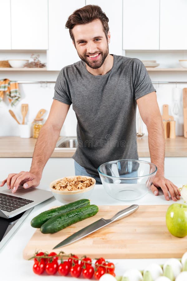 Joyful Young Guy Cooking at Home Stock Photo - Image of computer, house ...