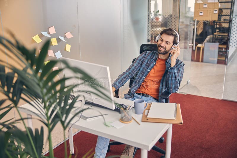 Joyful Young Man Using Computer at Work Stock Photo - Image of music ...