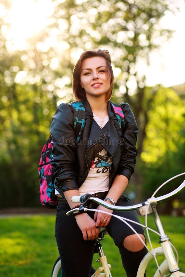 Joyful Young Woman on Bicycle in Green Park on Sunset Stock Photo ...