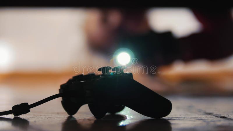 Joystick Under the Bed. Girl with Flashlight Looking Under the Bed ...