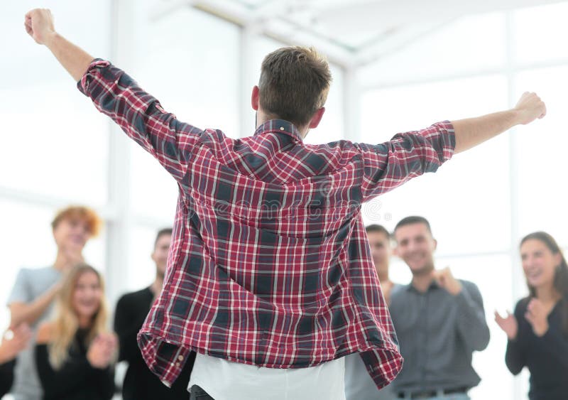 Jubilant Leader Standing in Front of the Business Team. Stock Photo ...