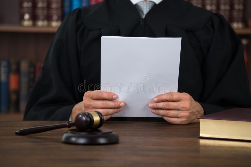Judge Reading Paper in Courtroom Stock Photo - Image of document ...