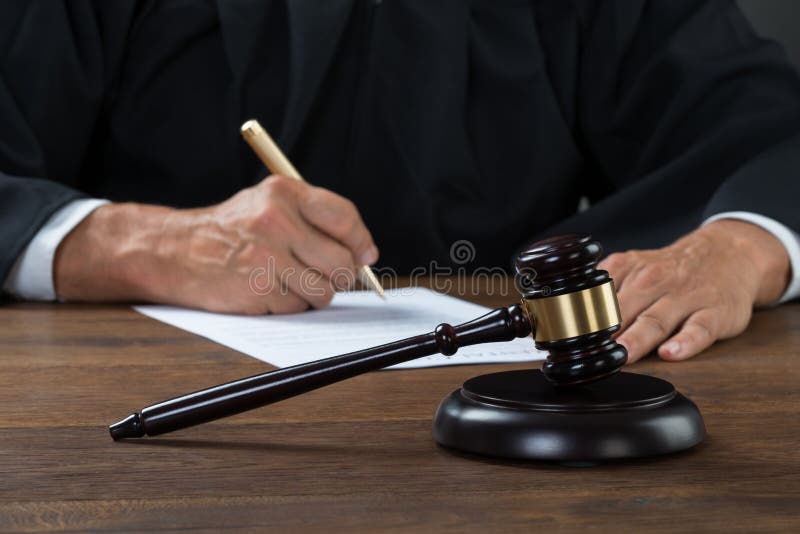 Judge Writing on Paper in Courtroom Stock Photo - Image of holding ...